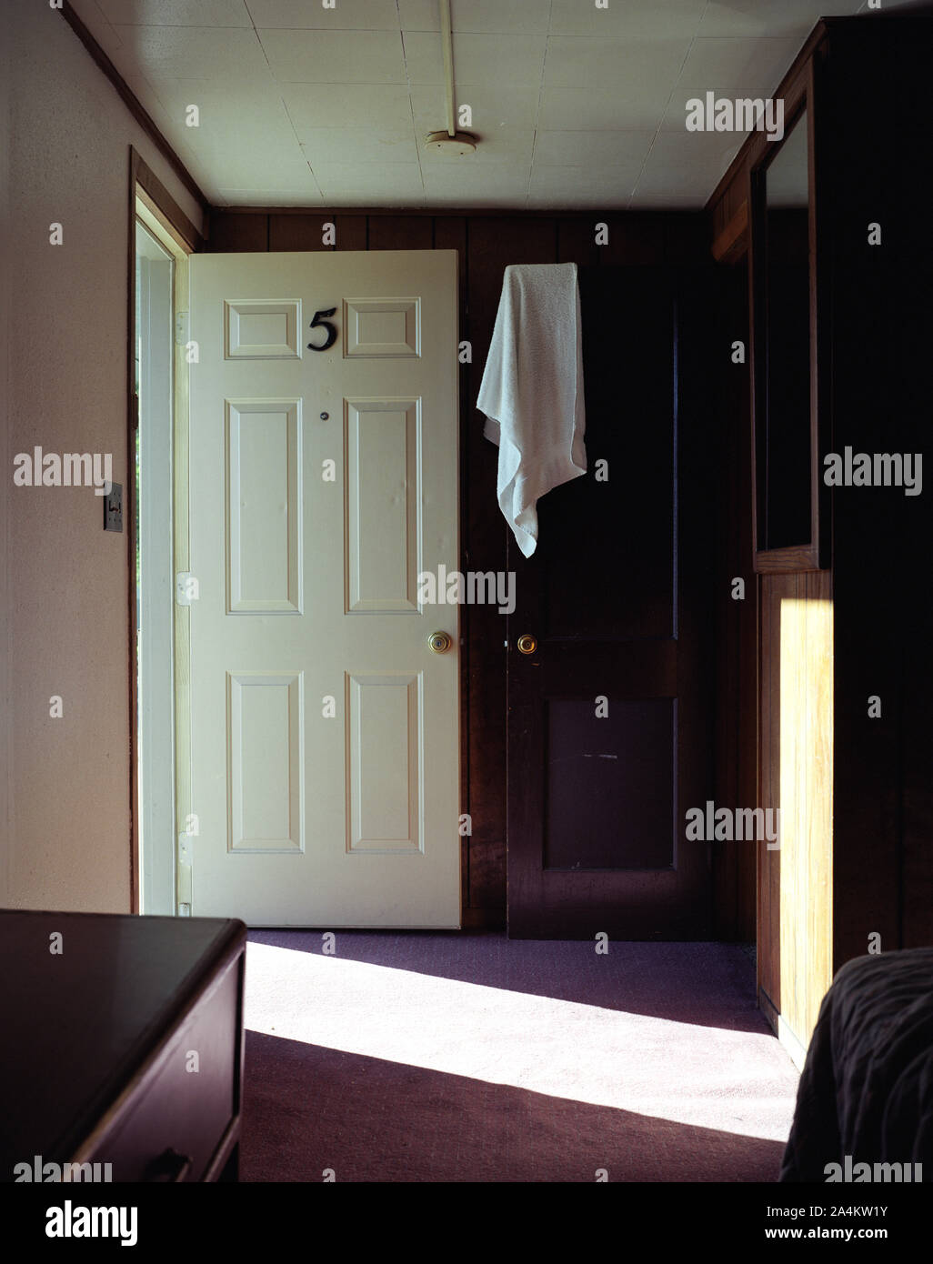 Hotel room number 5. Open door Stock Photo - Alamy