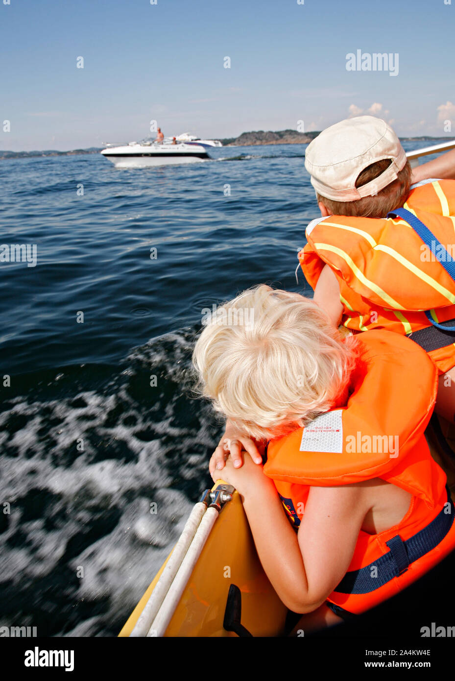 Children with life jackets in boat Stock Photo - Alamy