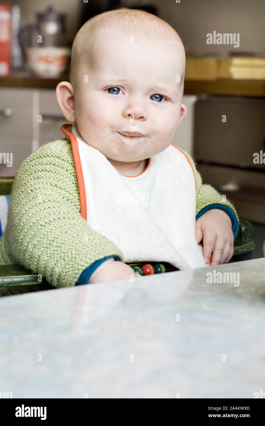 Hungry baby in baby chair Stock Photo - Alamy
