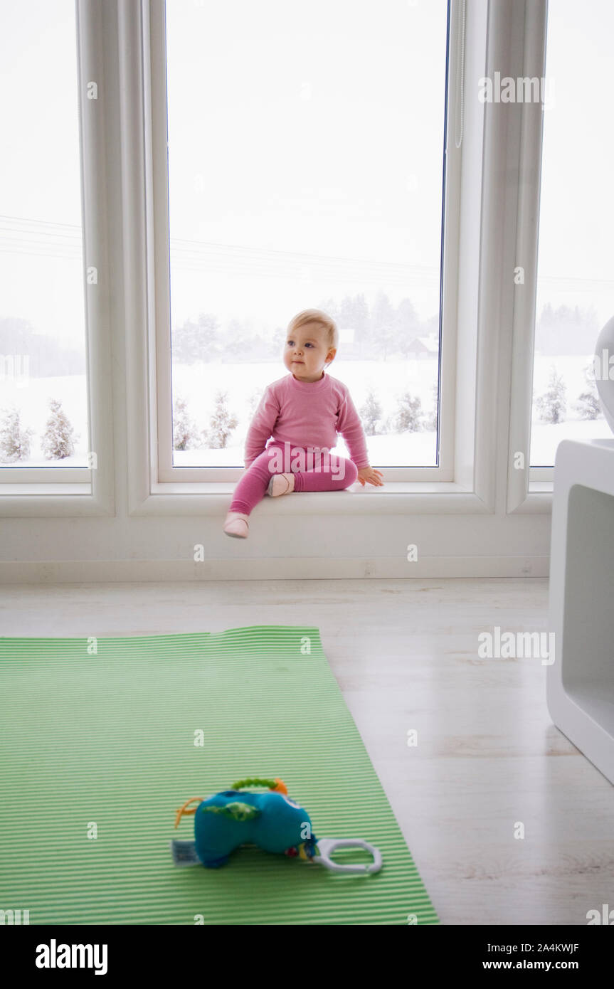 Baby resting in a window Stock Photo - Alamy