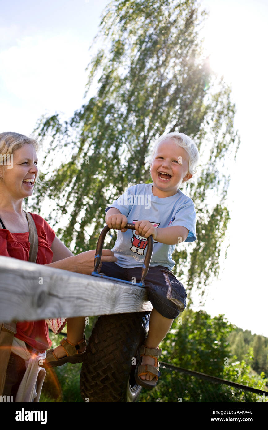 Children playing on teeter totter hi-res stock photography and images ...