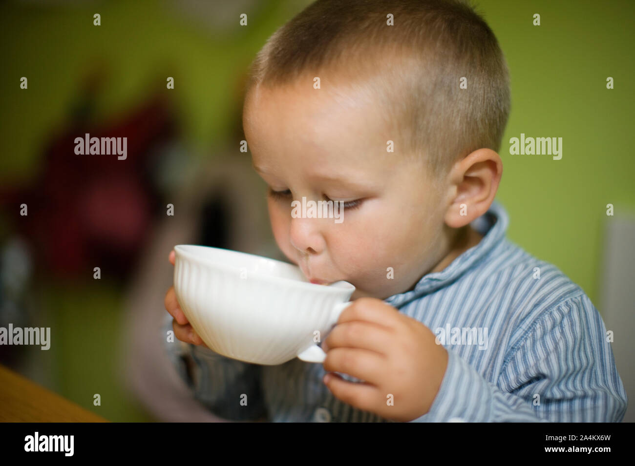 Boy drinking from cup Stock Photo - Alamy