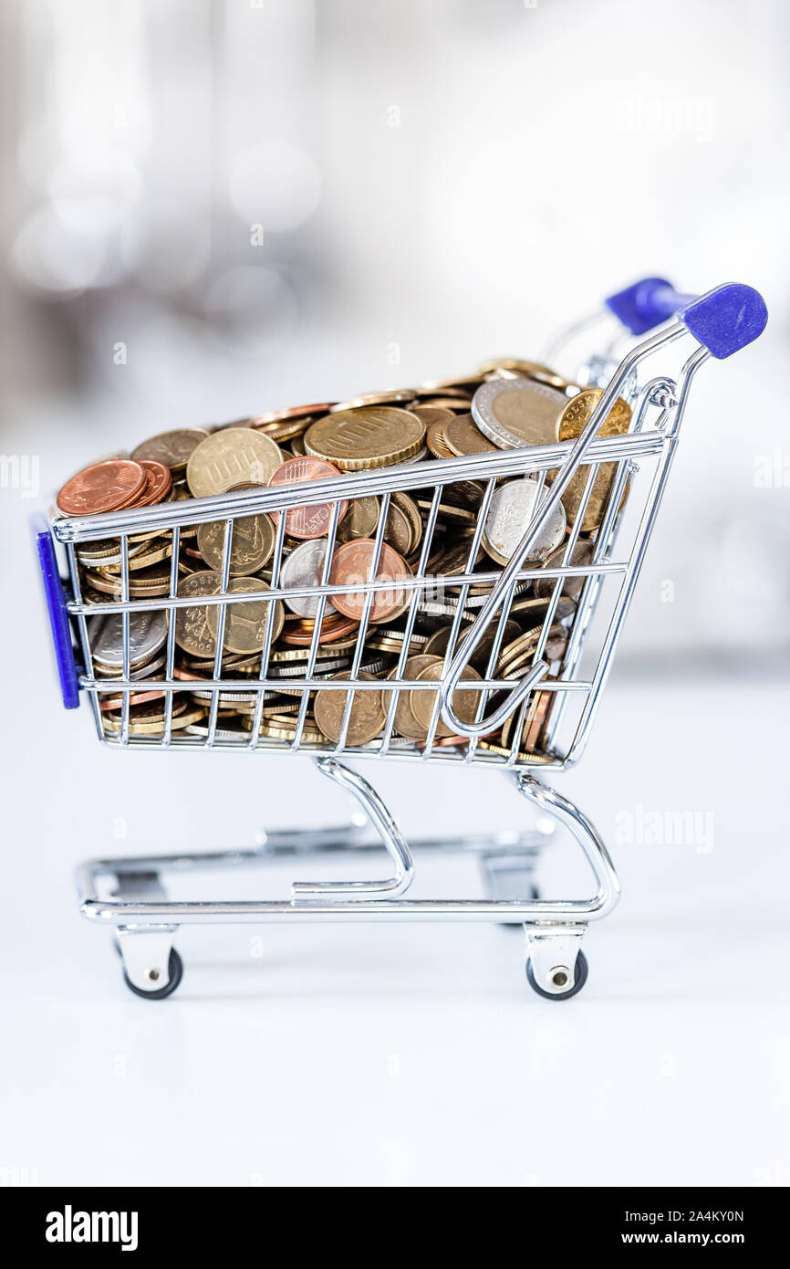 Shopping trolley with small coins Stock Photo - Alamy