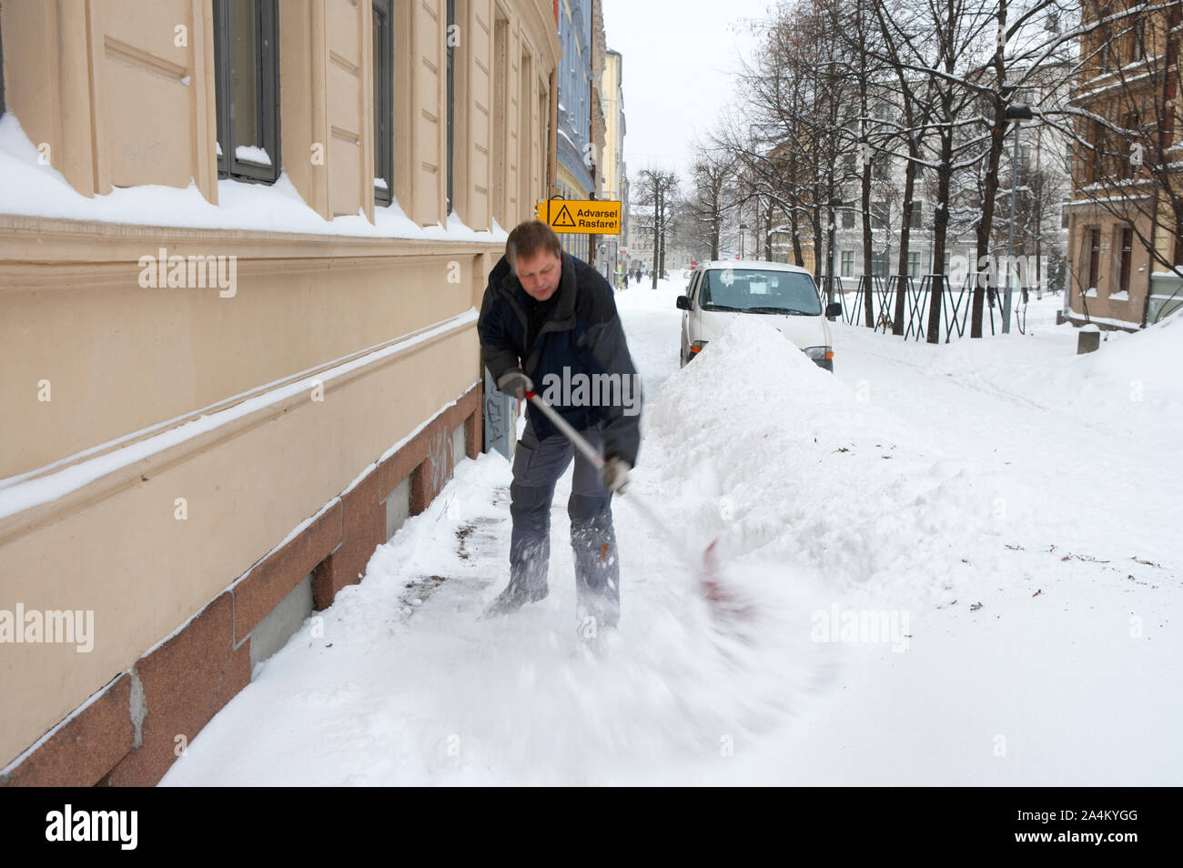 Clearing snow from pavement Stock Photo - Alamy
