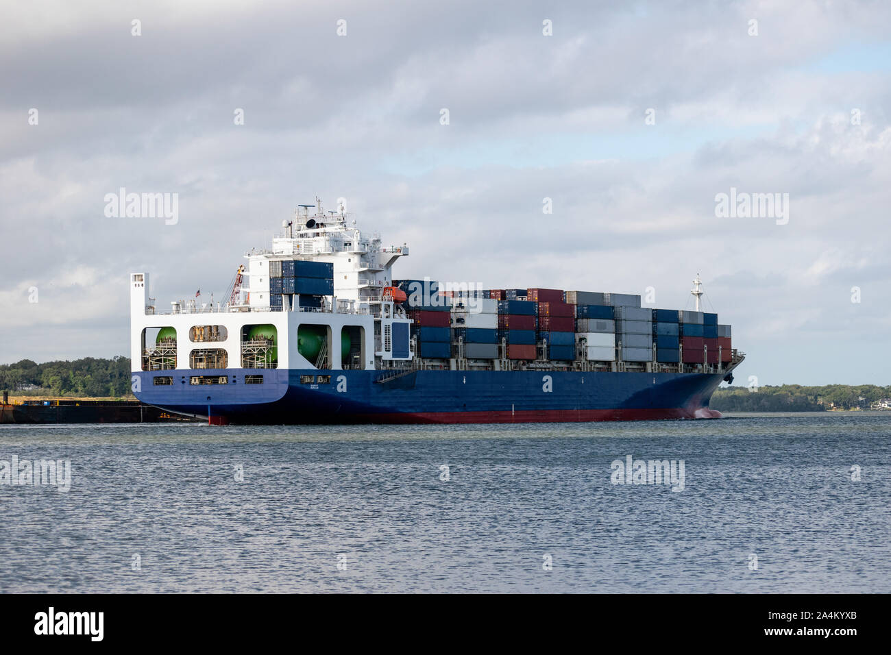 Large cargo container ship passing through river Stock Photo - Alamy