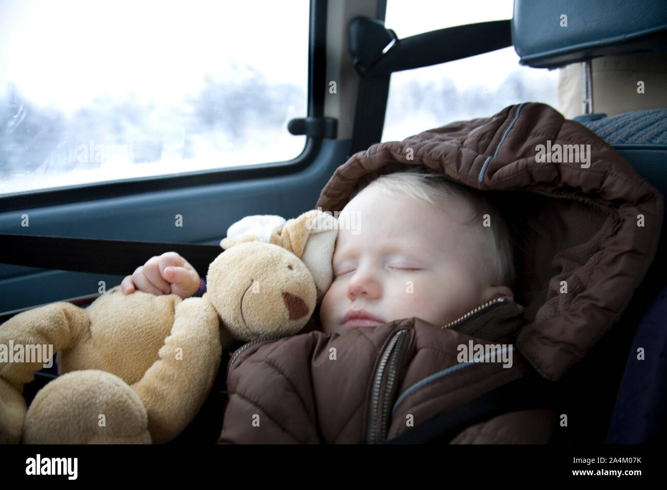 Baby sleeping in a car Stock Photo - Alamy