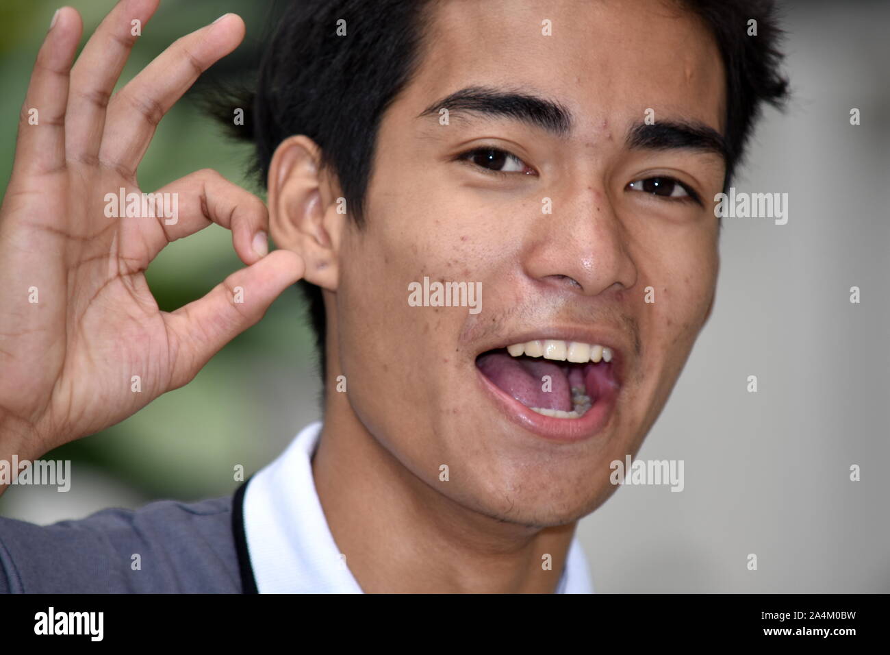 Young Asian Person And Okay Sign Stock Photo - Alamy