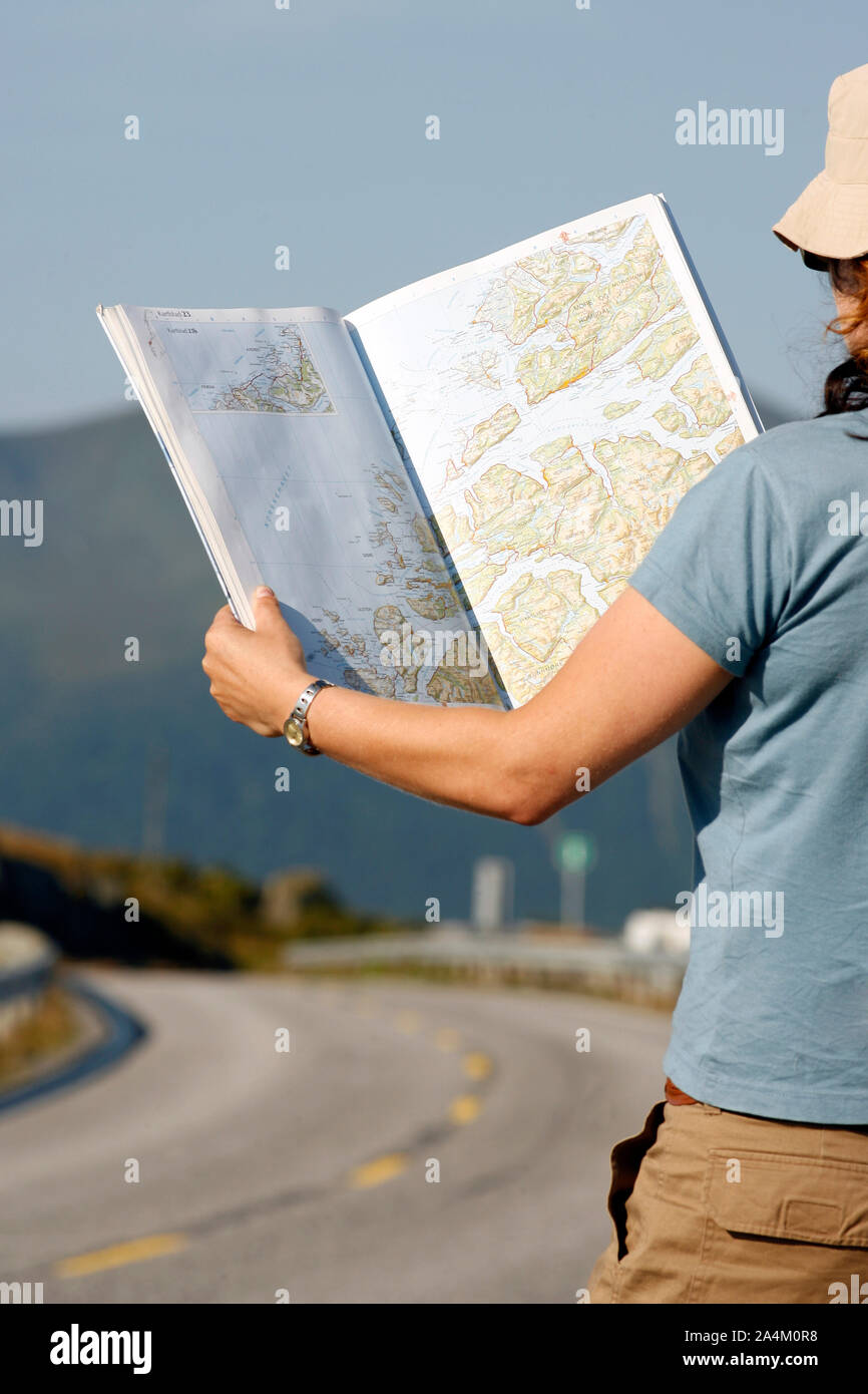 Guy reading a map book Stock Photo - Alamy