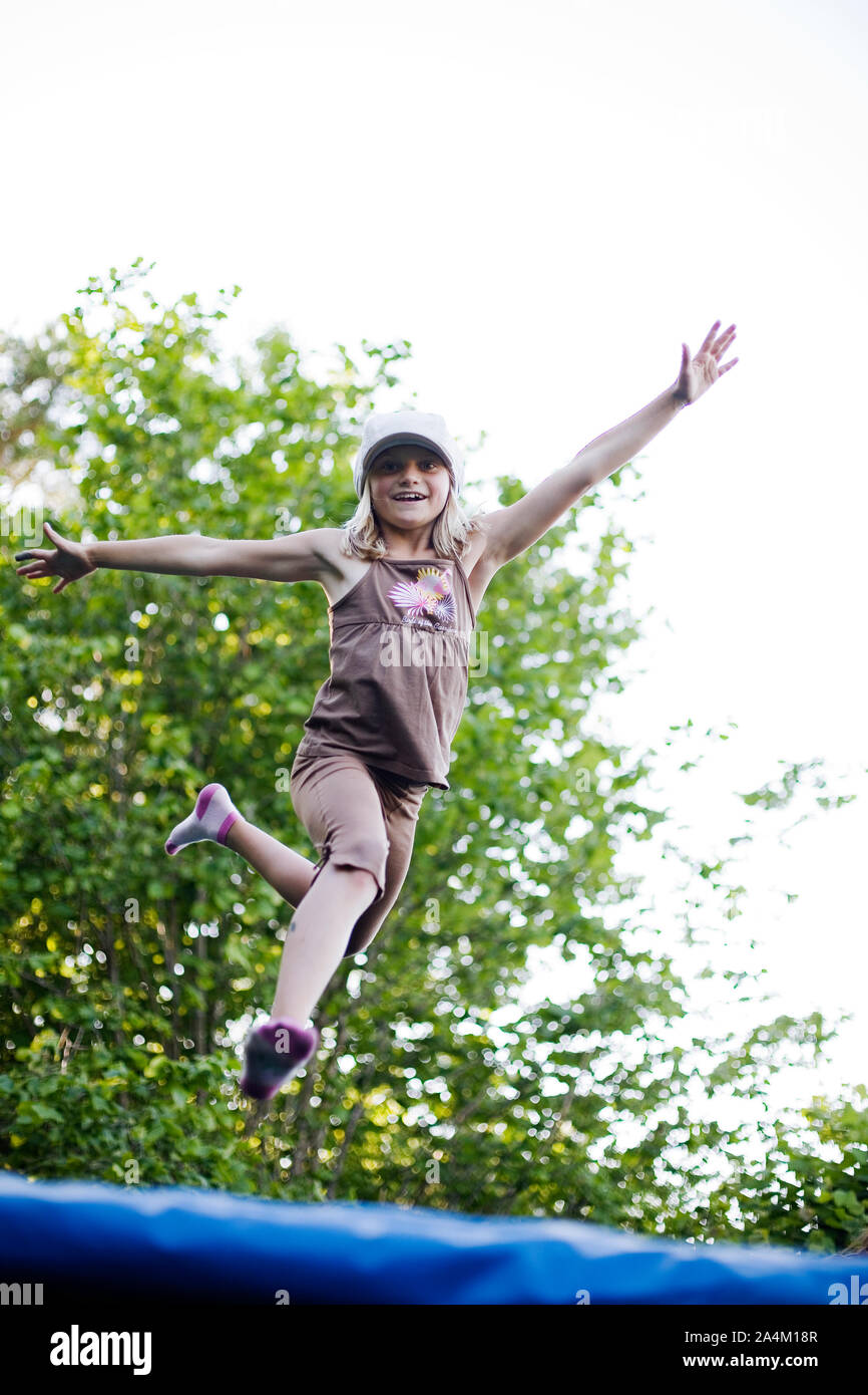 Girl playing on springboard Stock Photo - Alamy