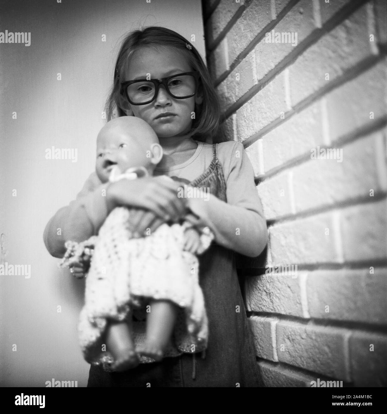 Girl with doll Stock Photo - Alamy