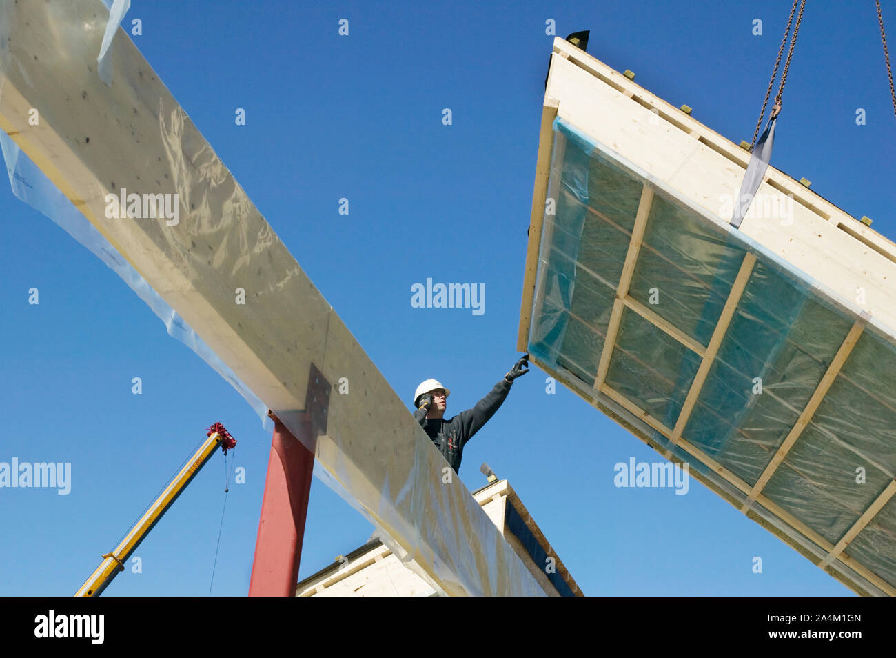 Man constructing a house - building elements Stock Photo - Alamy
