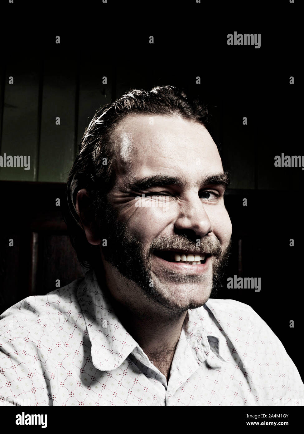 Man smiling. Wink at someone. Winking Stock Photo - Alamy