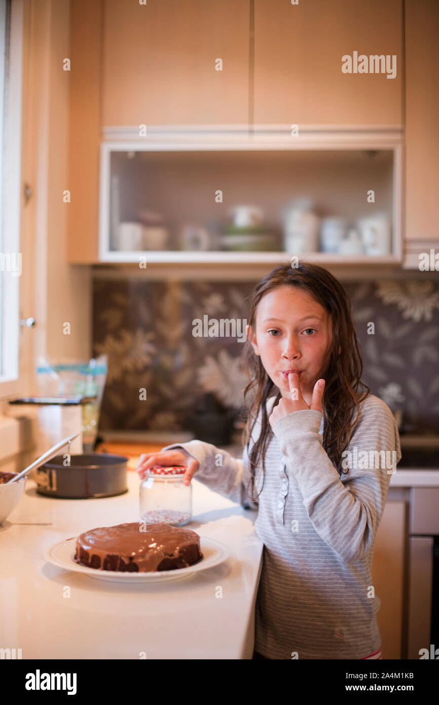 Girl making chocolate cake Stock Photo - Alamy