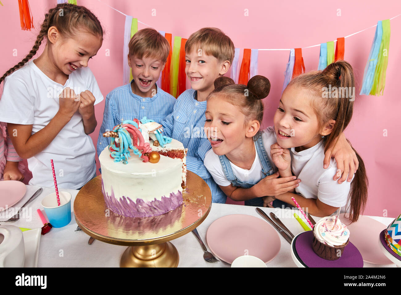 Happy group of children rejoicing at the look of birthday cake, kids ...