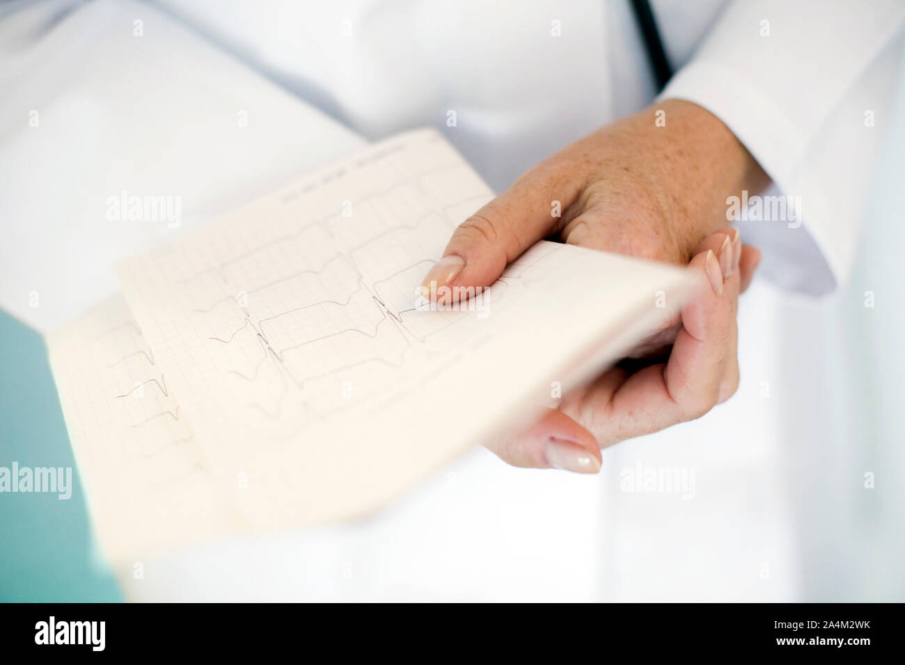 Doctor holding ECG chart Stock Photo - Alamy