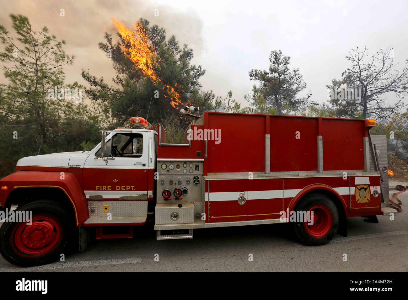 Beirut, Lebanon. 15th Oct, 2019. A fire engine puts out a fire in Chouf ...