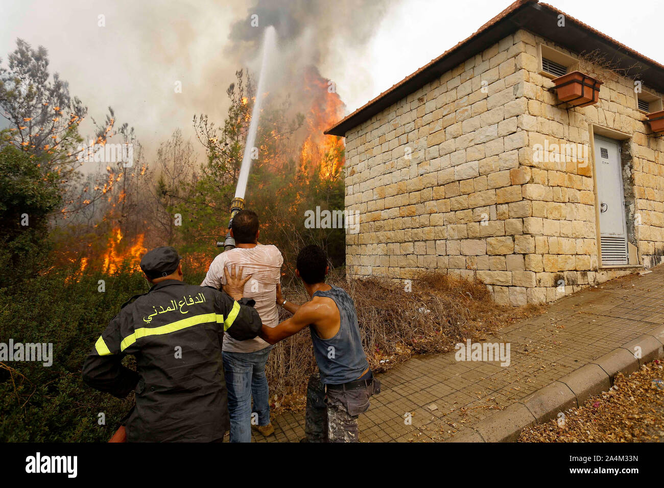 Beirut, Lebanon. 15th Oct, 2019. People try to put out a fire in Chouf ...