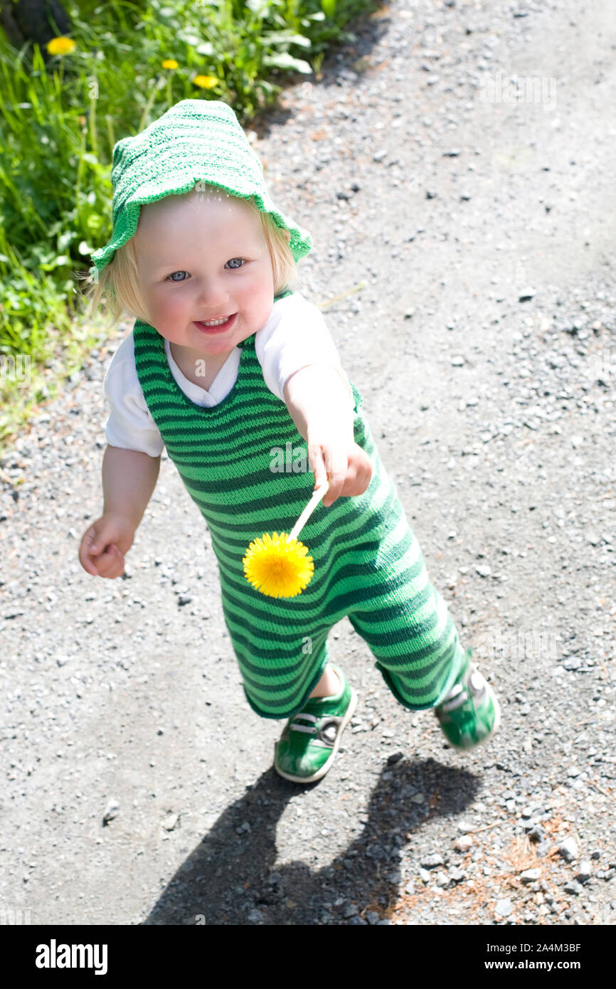 Portrait of child giving flower Stock Photo - Alamy