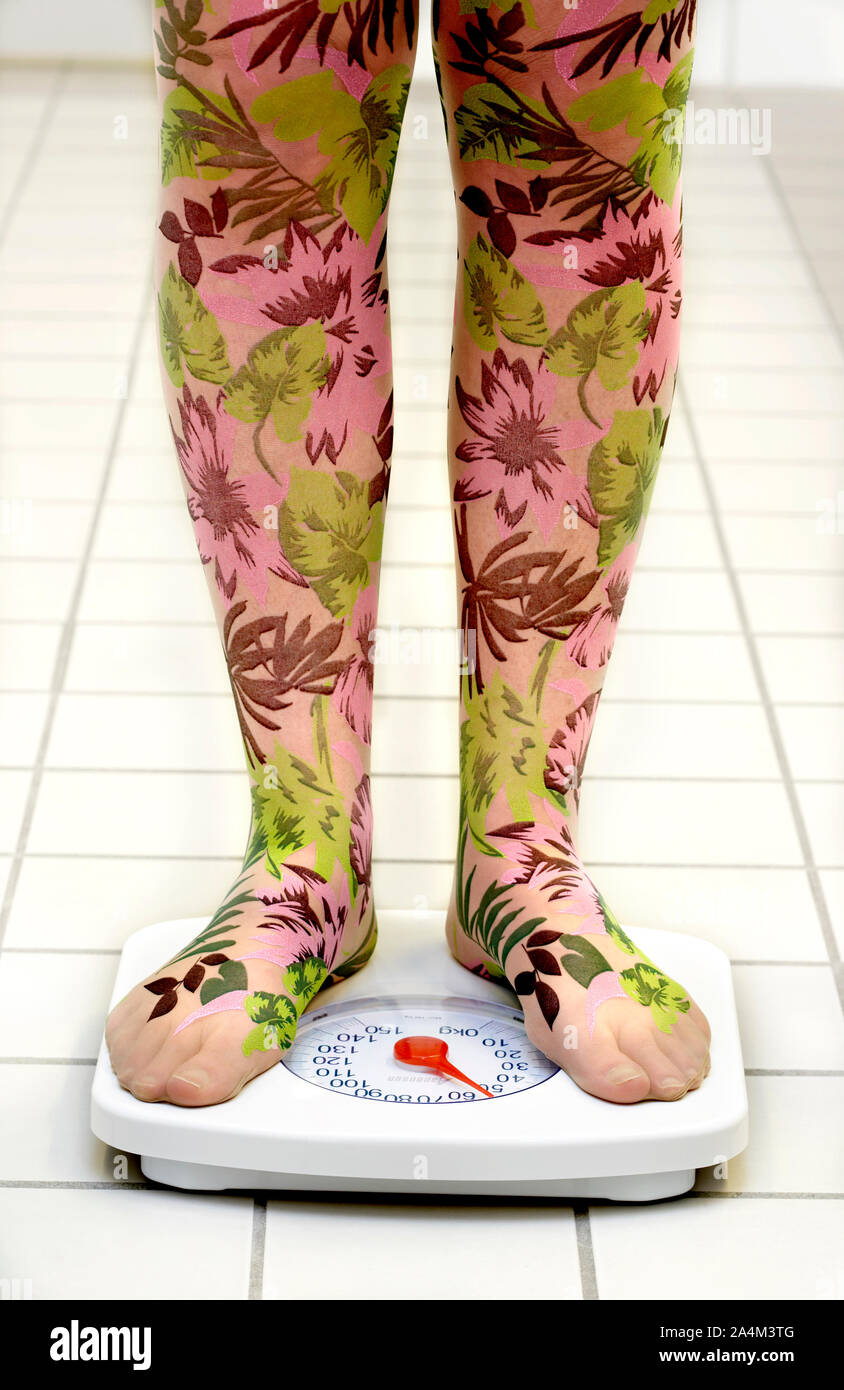 Standing on bathroom scale Stock Photo - Alamy