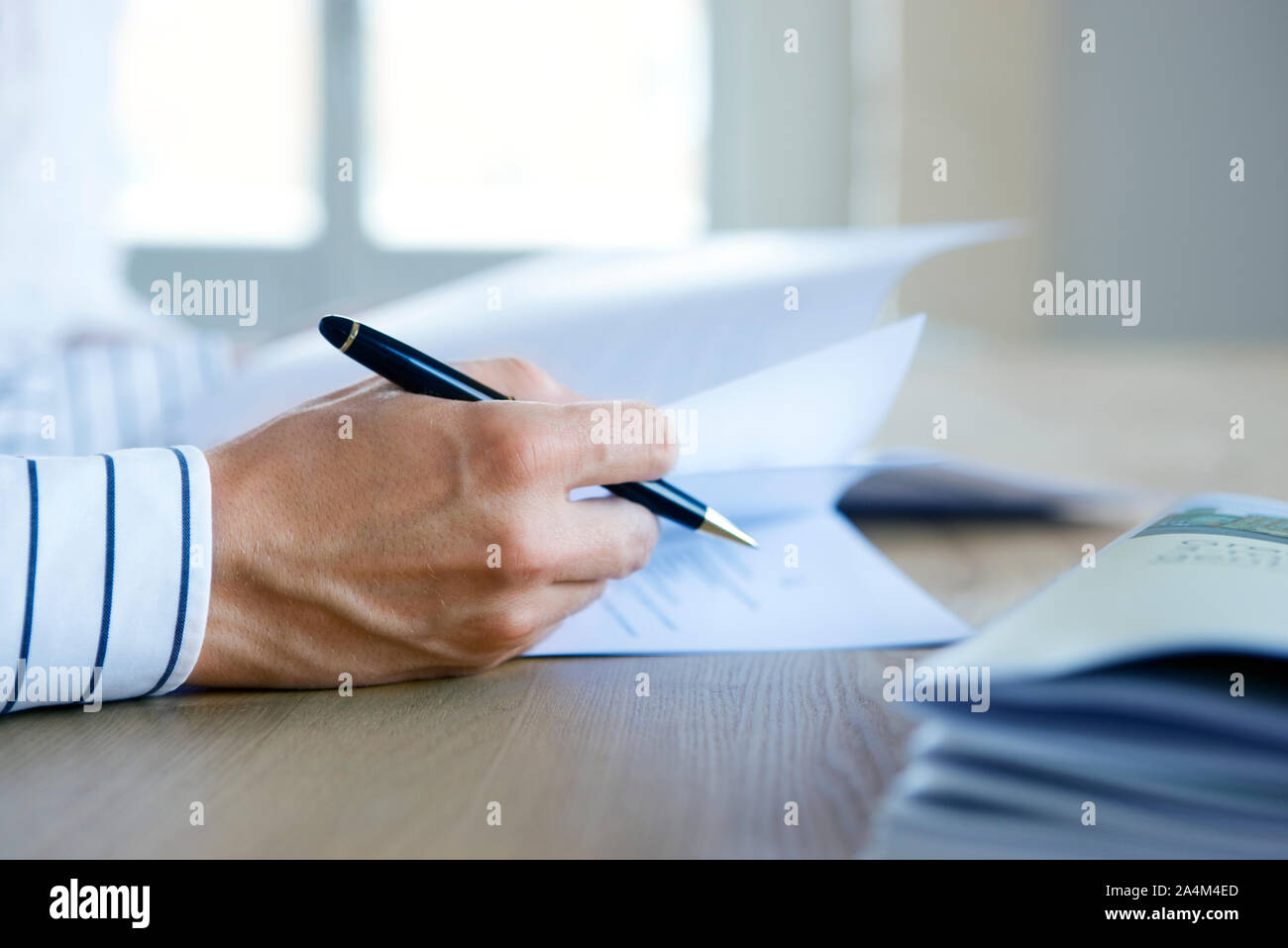 Reading a document - signing a contract Stock Photo - Alamy