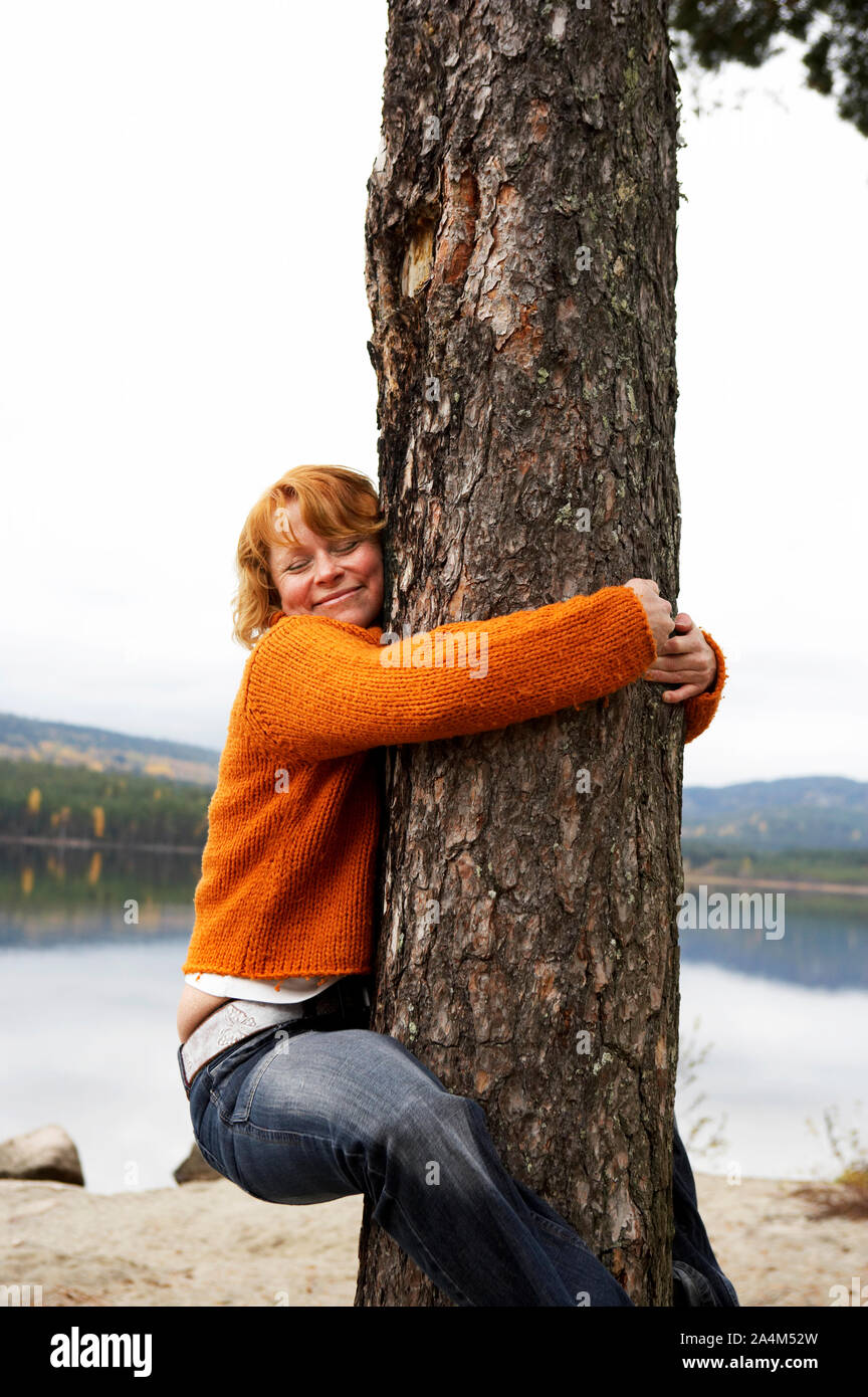 Woman hugging a tree - tree hugger/tree huggers Stock Photo - Alamy