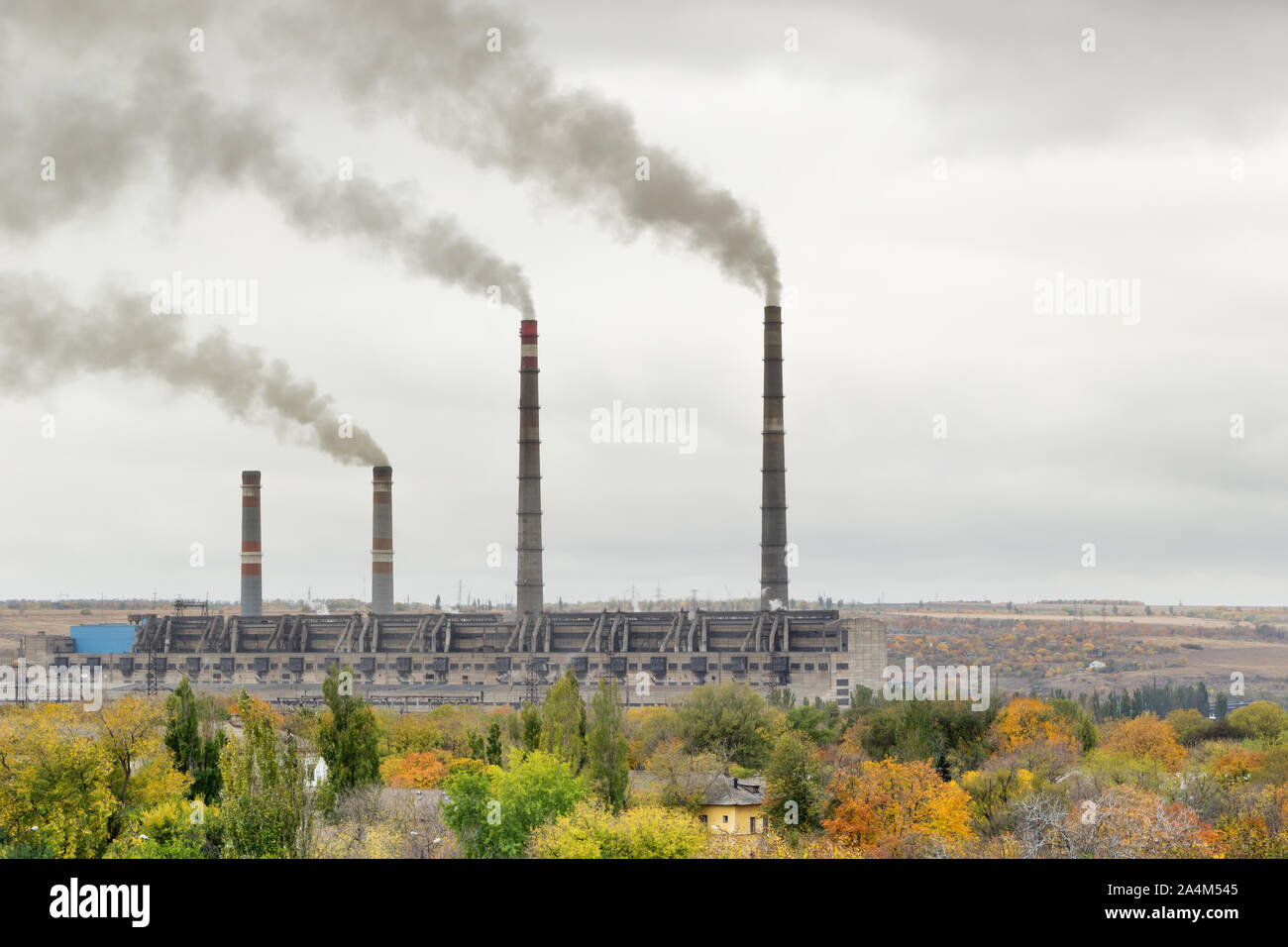 Air pollution concept. Thermal power station building with smokestacks ...