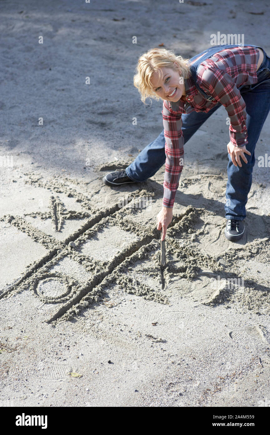 Woman writing in sand hi-res stock photography and images - Alamy