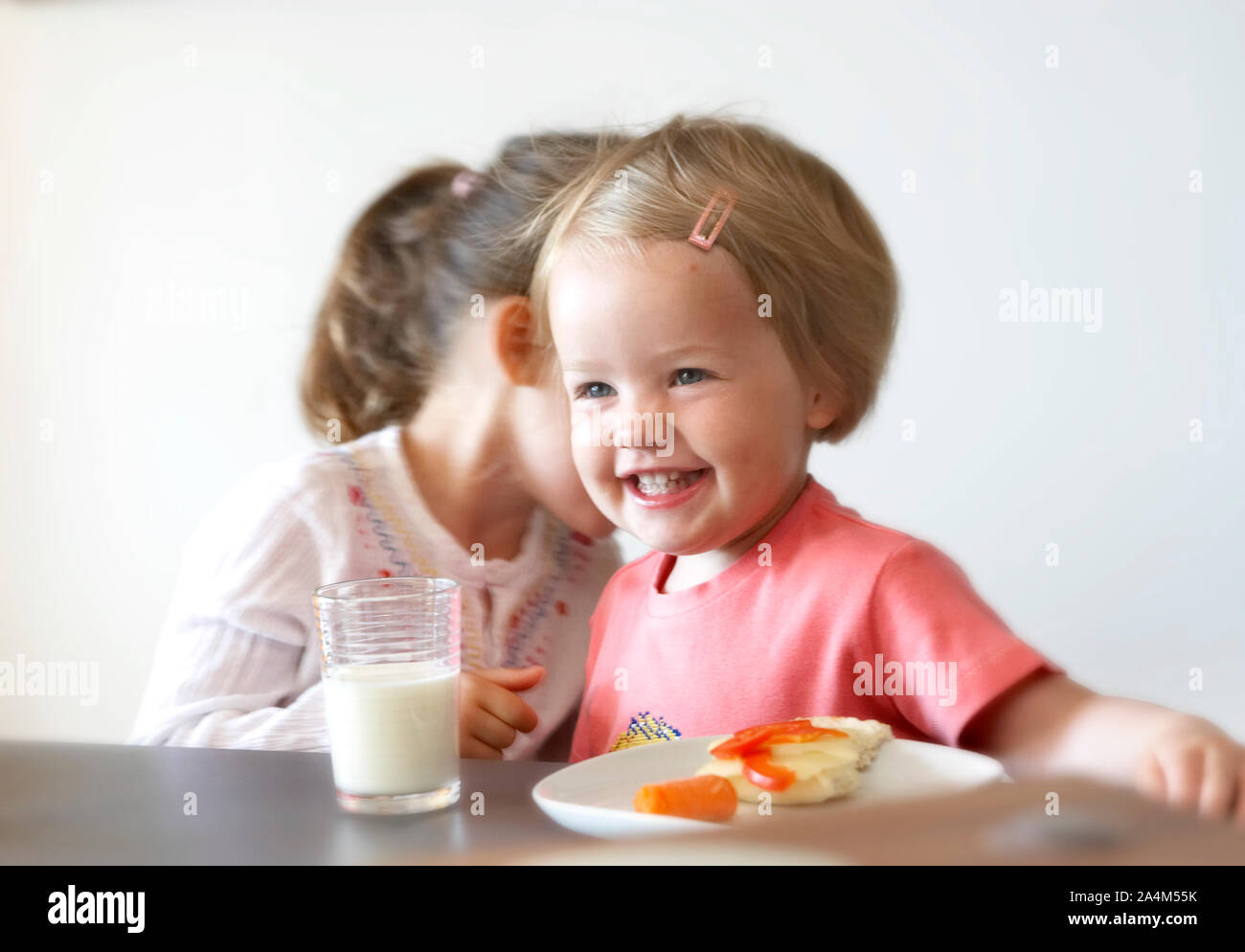 Sisters whispering secrets hi-res stock photography and images - Alamy