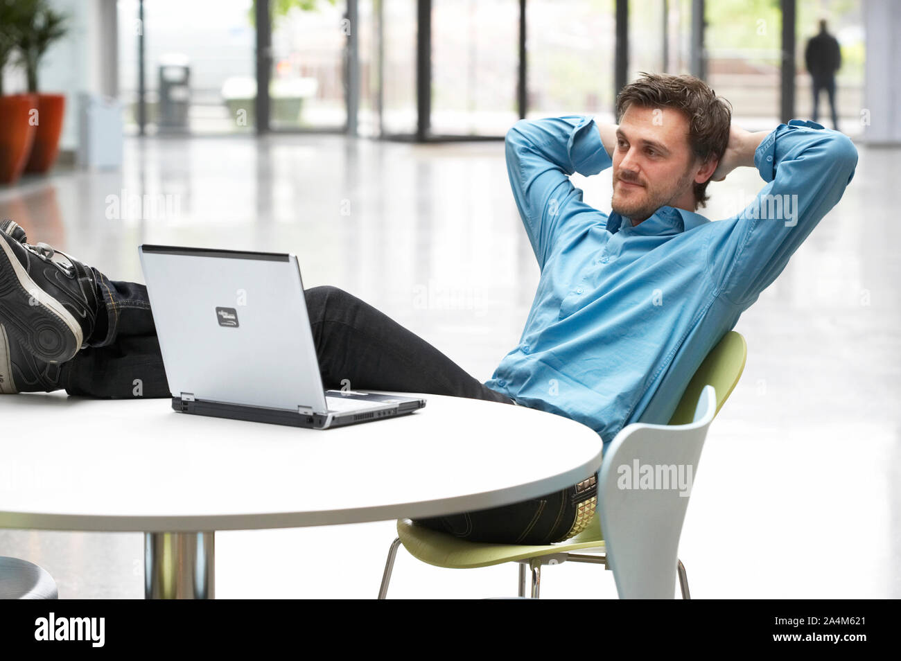 Young man daydreaming at work Stock Photo - Alamy