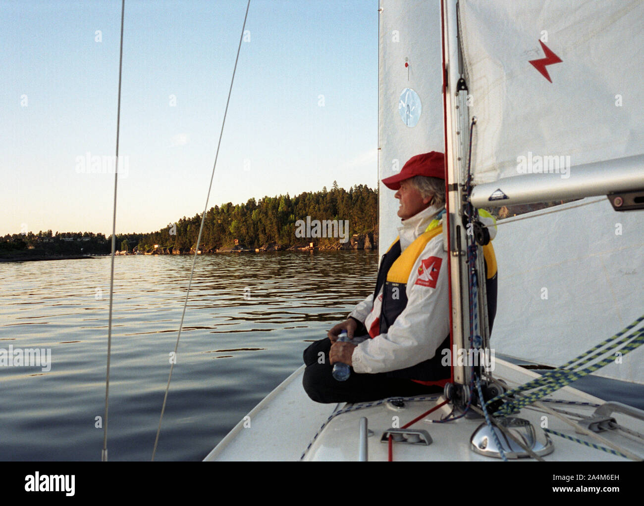 Man in sailing boat Stock Photo - Alamy