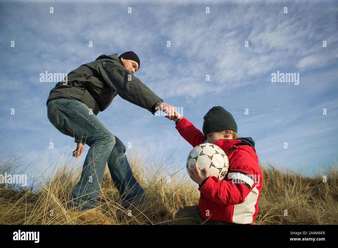 Father and son - helping hand - help support - helpful Stock Photo - Alamy