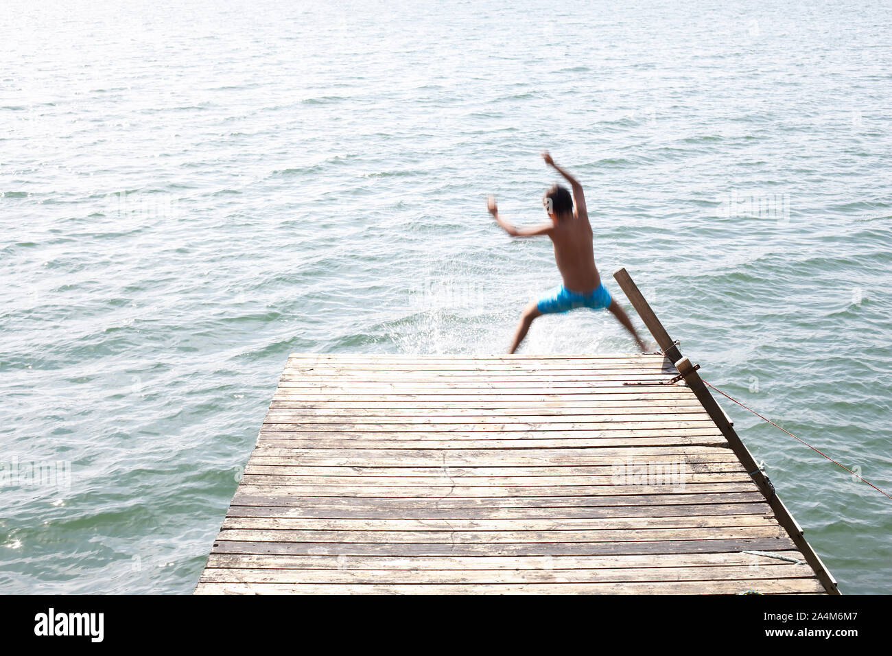 Boy jumping in sea Stock Photo - Alamy
