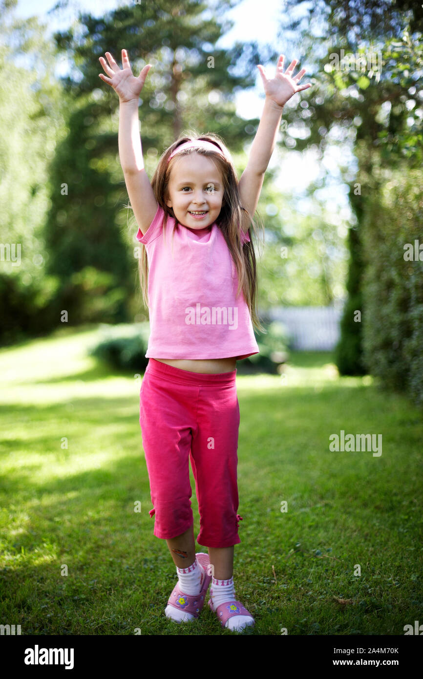 Girl standing on a lawn Stock Photo - Alamy