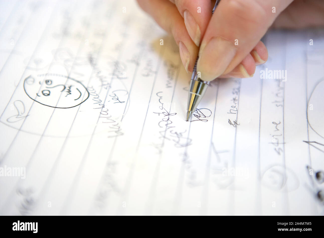 Person taking notes - homework Stock Photo - Alamy