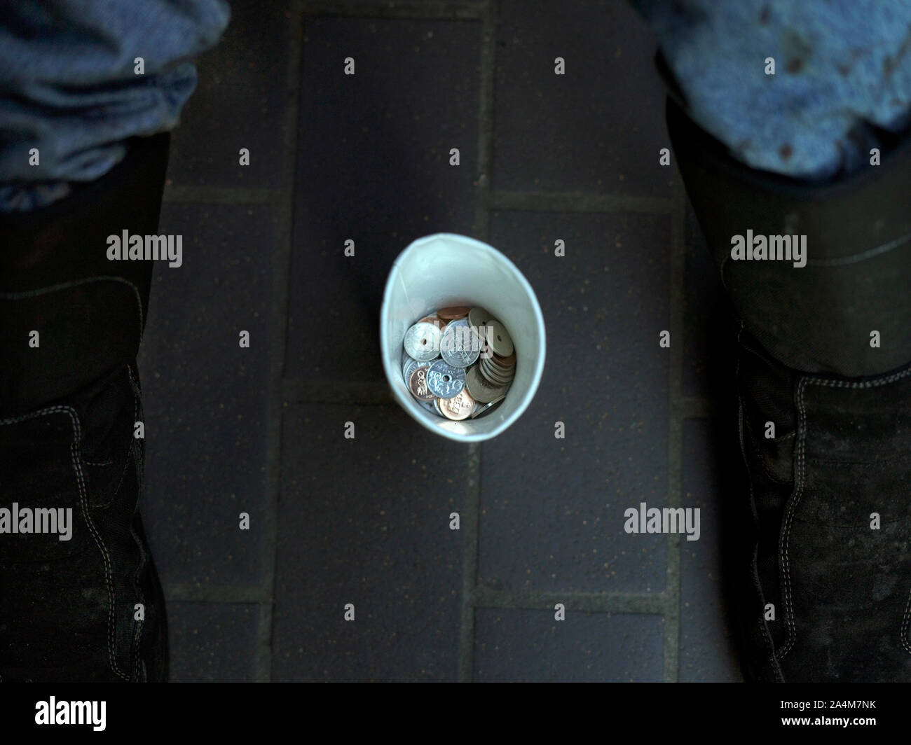 Begging cups hi-res stock photography and images - Alamy