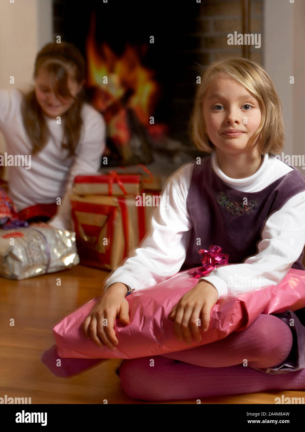 Girls opening Christmas presents Stock Photo - Alamy
