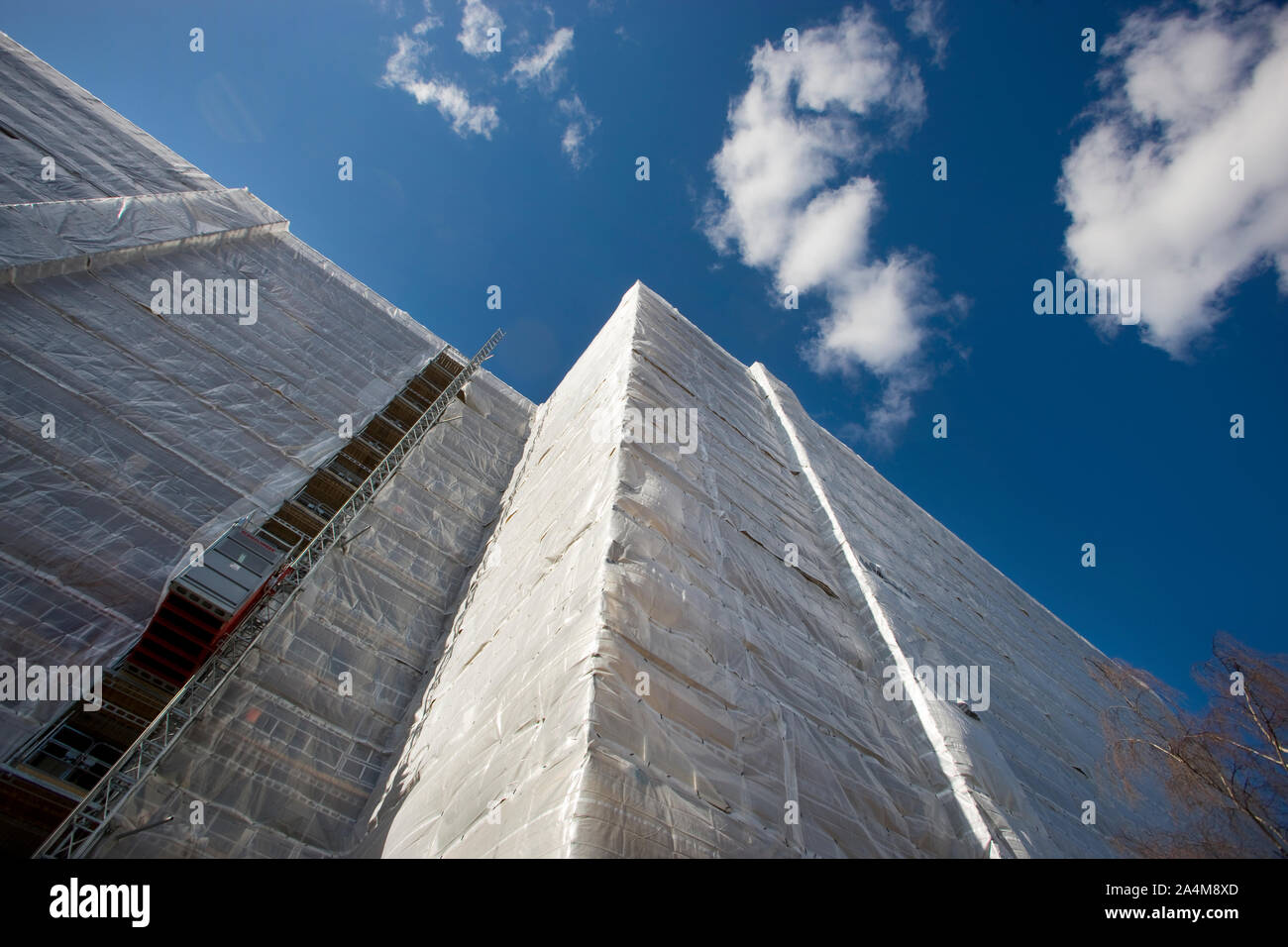 A building wrapped in plastic Stock Photo - Alamy