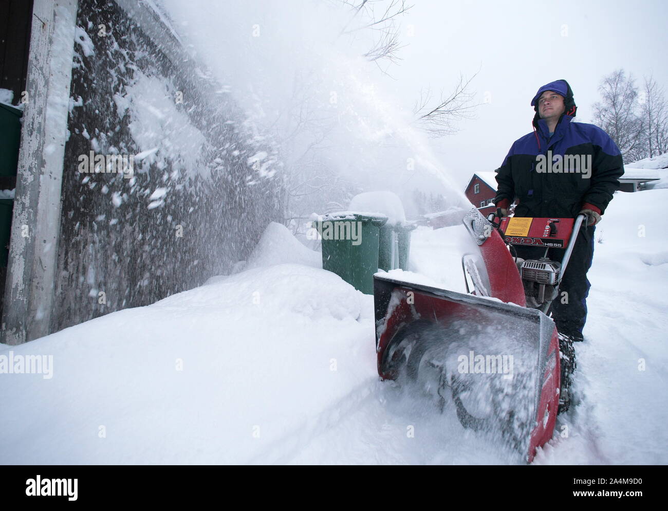 Man using snow blower/snowblower Stock Photo - Alamy