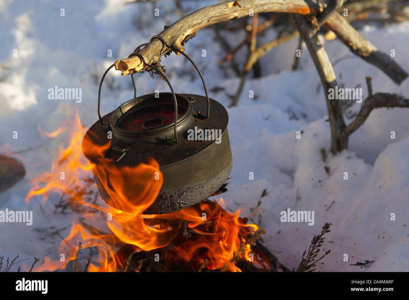 Cooking over open fire in snow Stock Photo - Alamy