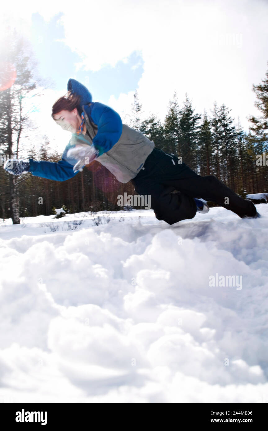 Girl jumping into snow Stock Photo - Alamy