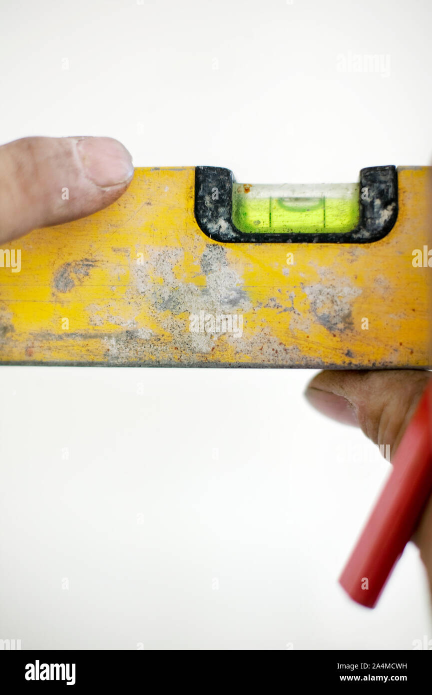 Using a level and pencil Stock Photo - Alamy