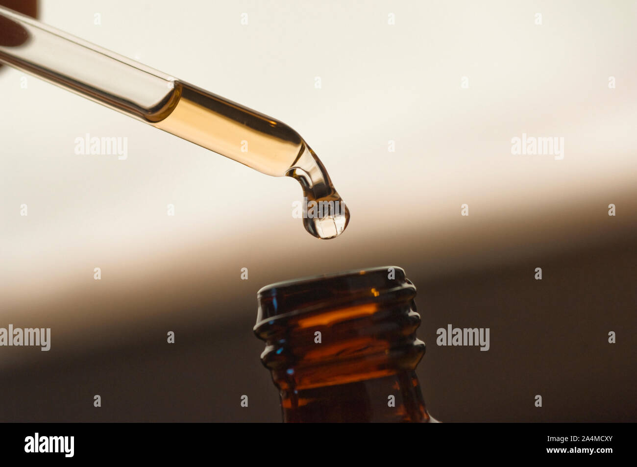 Drop pouring into bottle Stock Photo - Alamy
