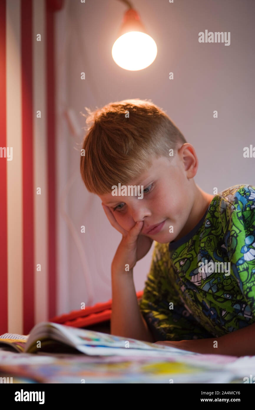 Boy reading magazine Stock Photo - Alamy