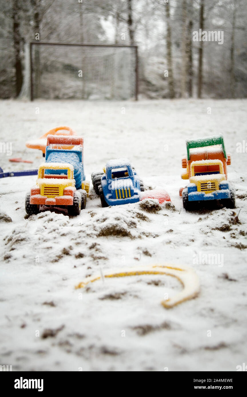 Plastic toy lorries in snow Stock Photo - Alamy