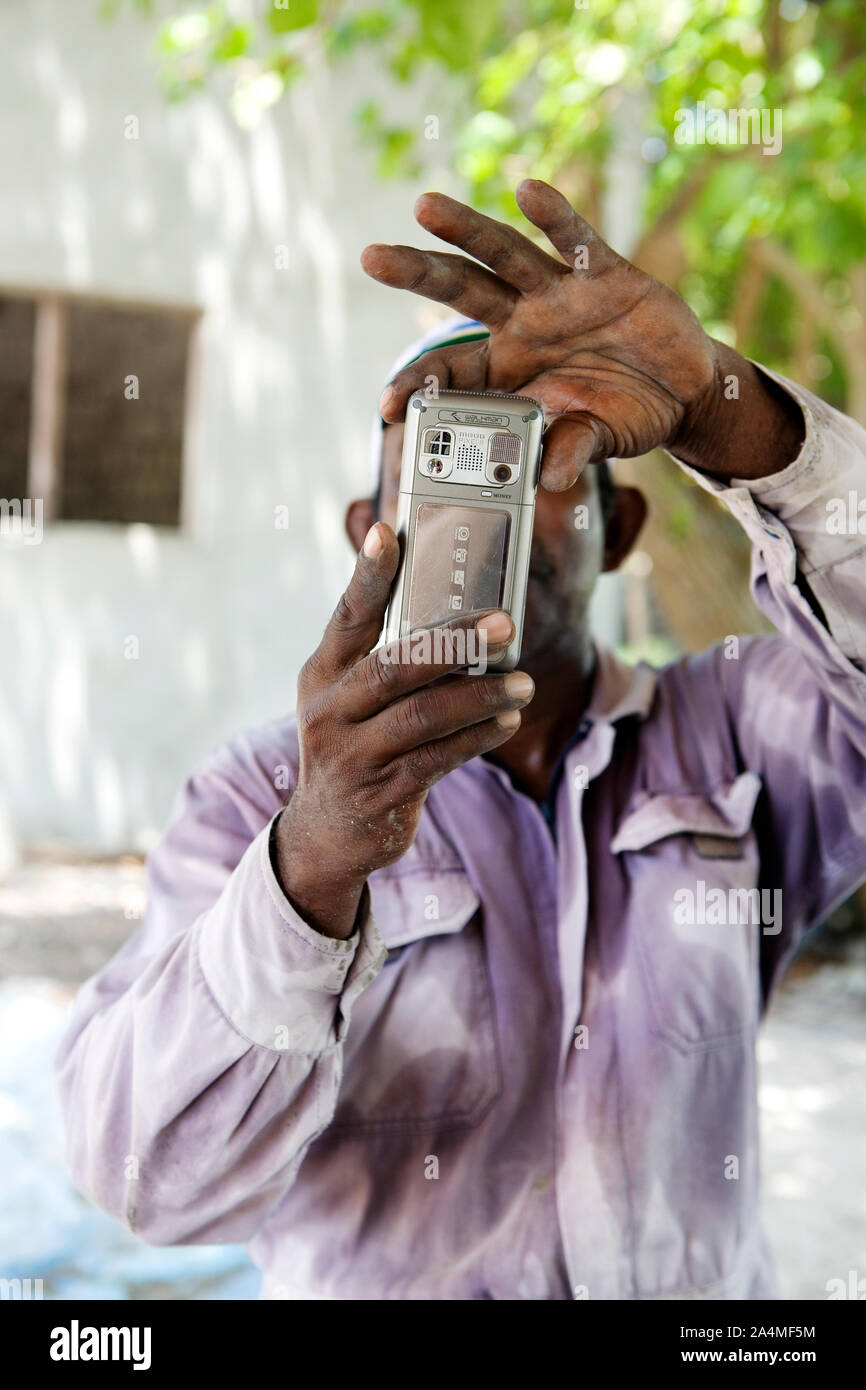 Man photographing outside his house in Kuredu island in the Maldives ...