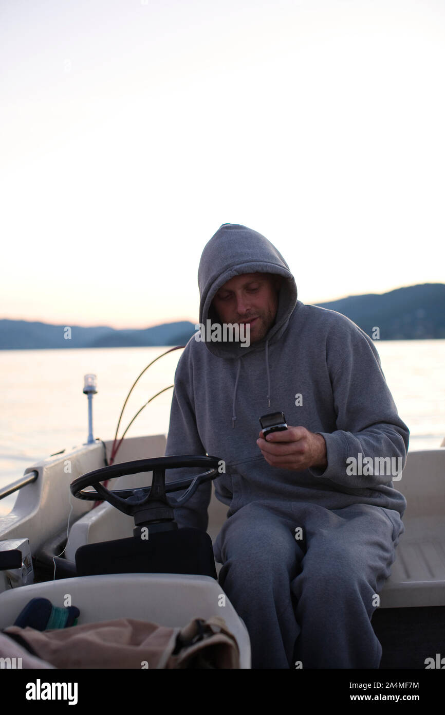 Man in motor boat Stock Photo - Alamy
