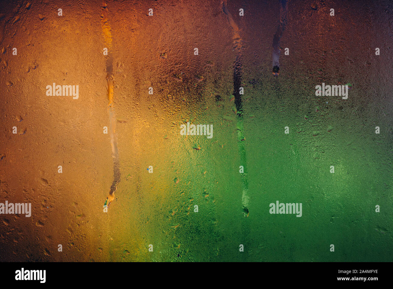 Water drops on surface of condensated glass with colored in green and ...