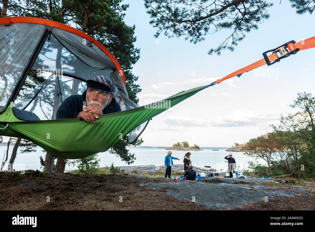 Man resting in hammock at lakeshore Stock Photo - Alamy