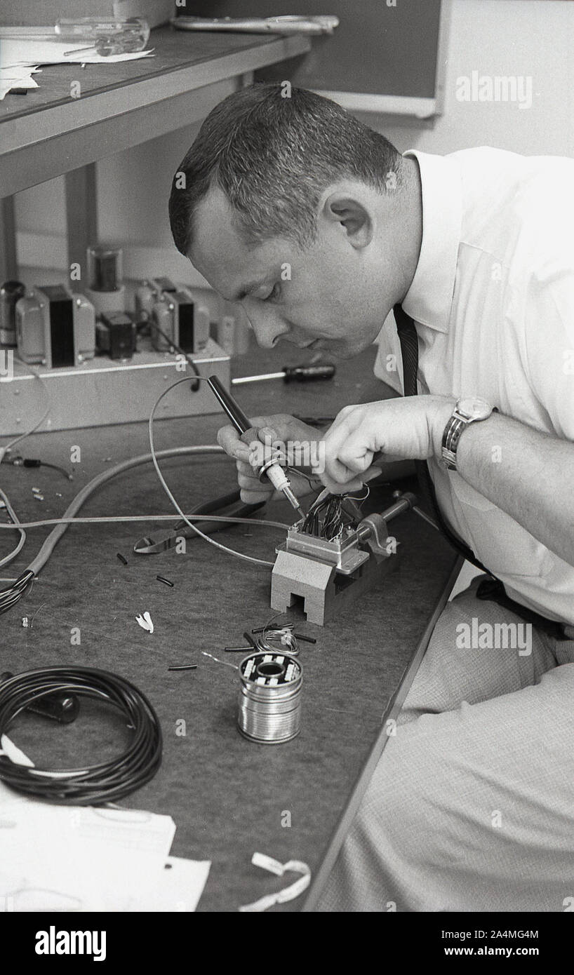 1960s, historical, an adult student working in a workshop, using a ...