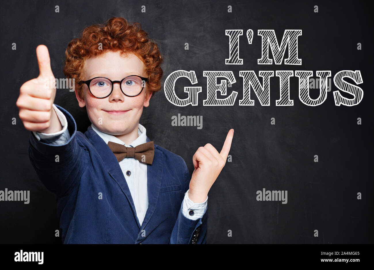 Happy little boy genius against chalkboard Stock Photo - Alamy